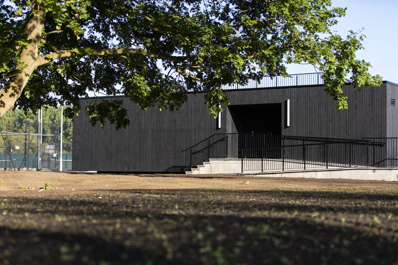 Eton College ‘floating’ charred timber sports pavilion completed by ...