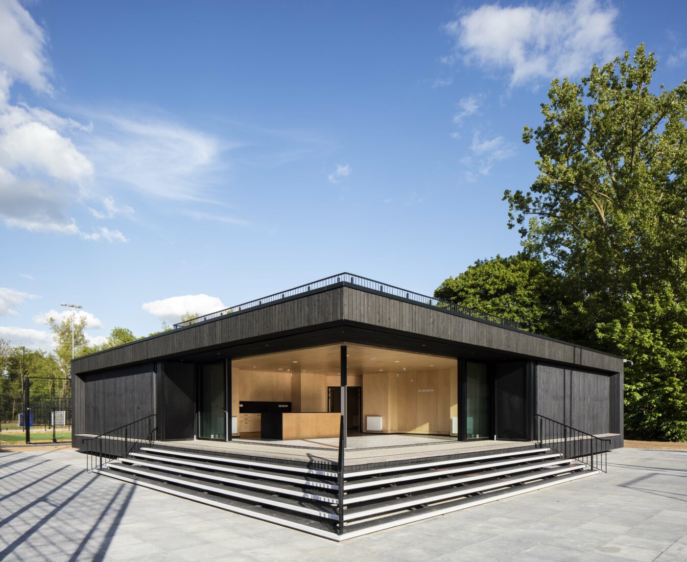 Eton College ‘floating’ charred timber sports pavilion completed by ...