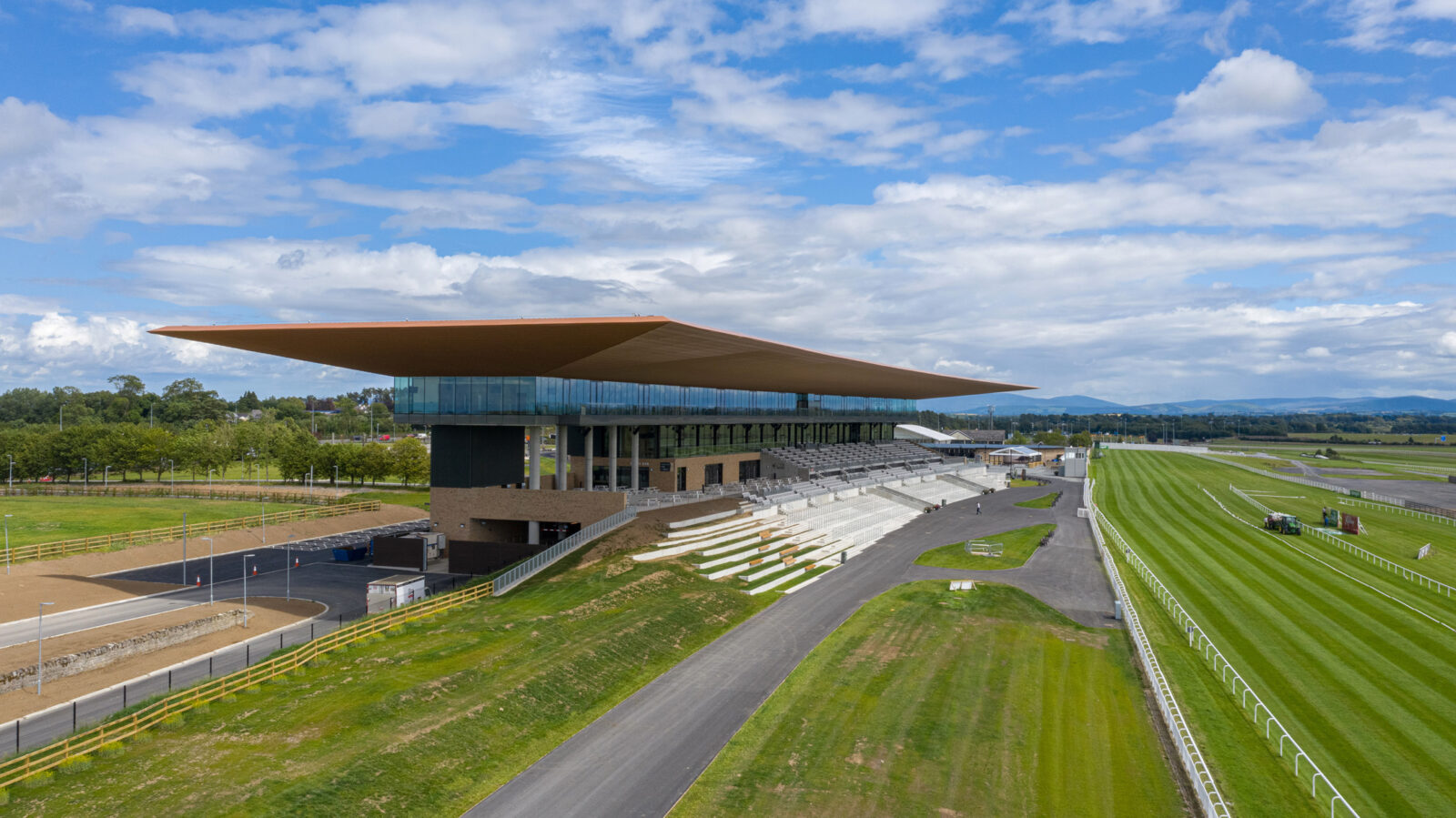 Floating copper roof marks out Grimshaw’s racecourse grandstand