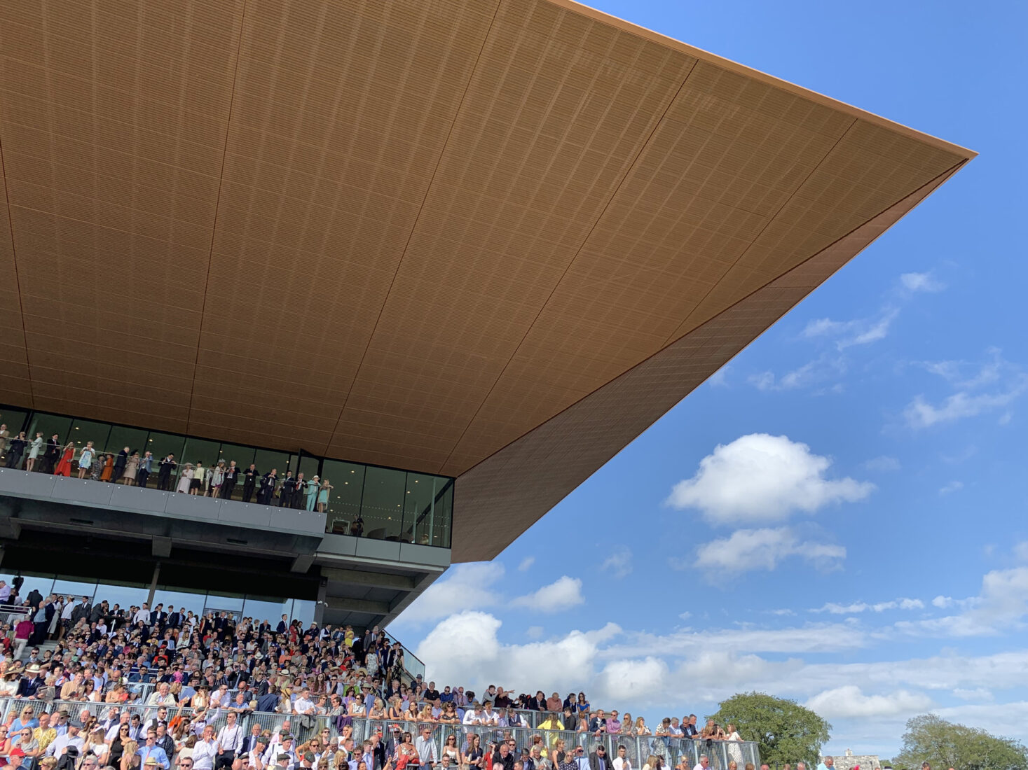 Floating copper roof marks out Grimshaw’s racecourse grandstand
