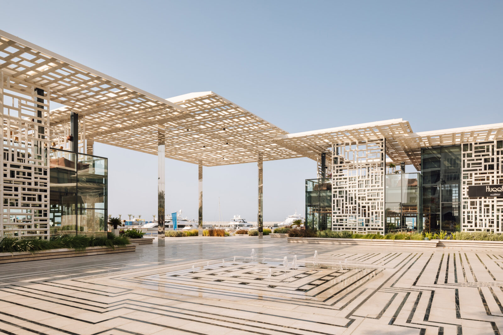ACME creates stone-fretted waterside square in Muscat