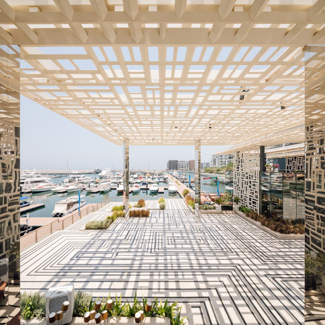 ACME creates stone-fretted waterside square in Muscat