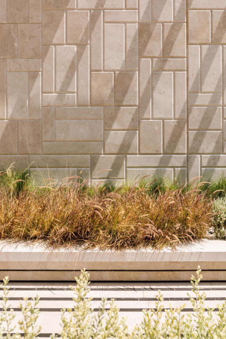 ACME creates stone-fretted waterside square in Muscat