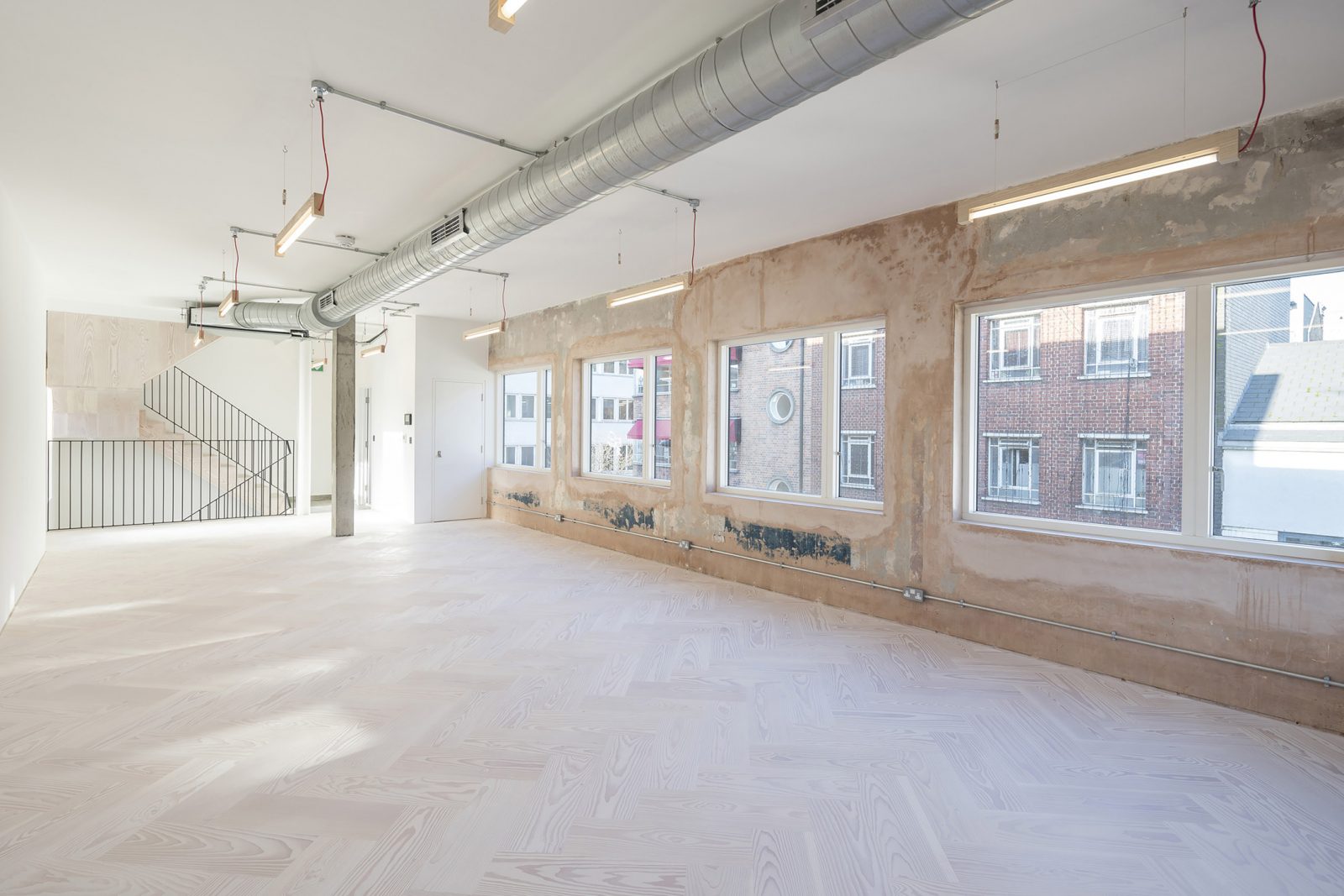 Stagg Architects opens up ‘introverted’ office building in detail-led ...