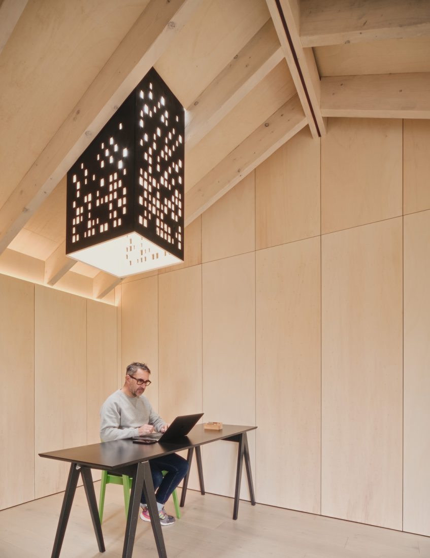 Hyperspace transforms old garage into ‘moody’ studio with bug-hotel façade