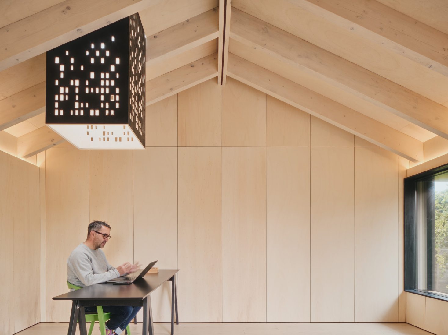 Hyperspace transforms old garage into ‘moody’ studio with bug-hotel façade