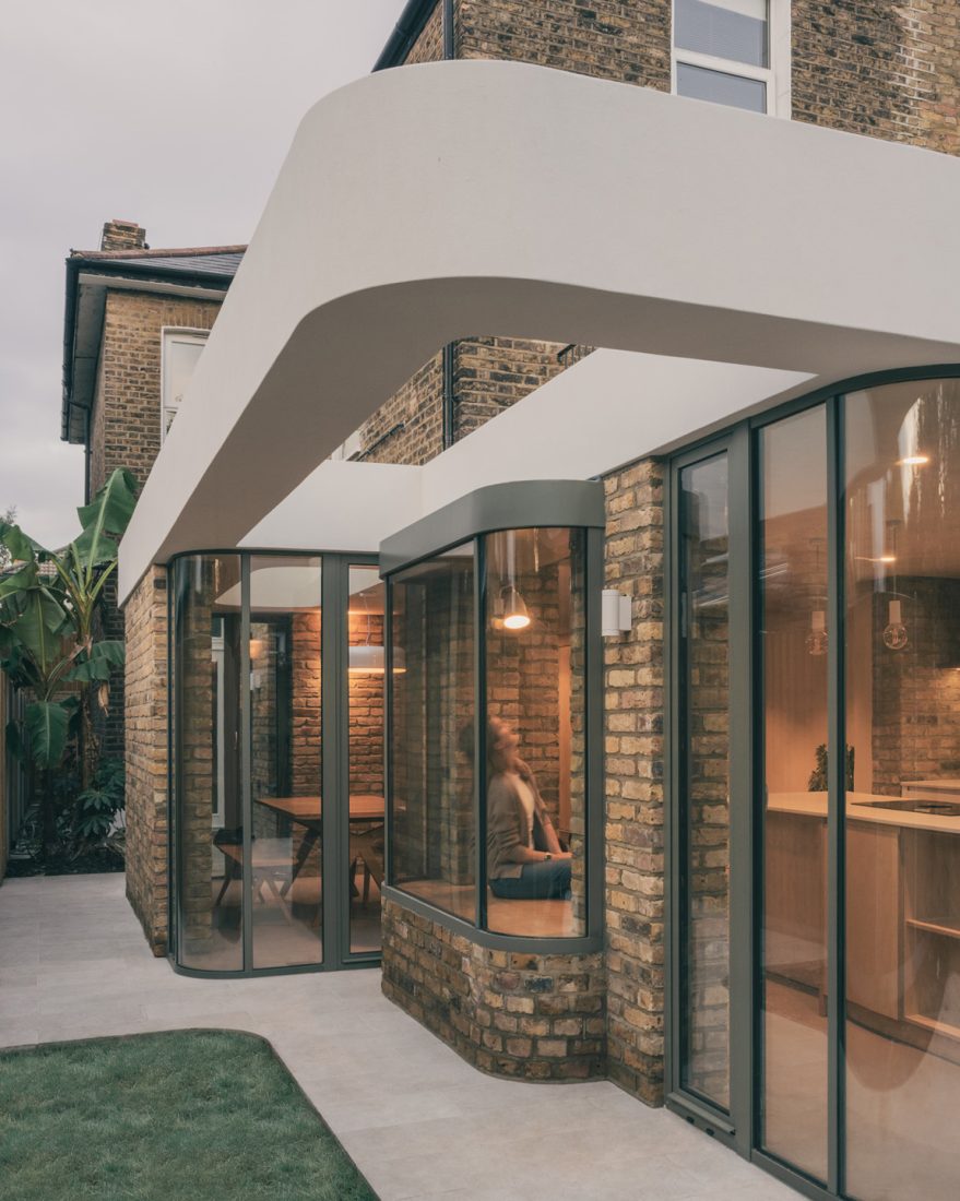 Pensaer completes curved glass-cornered extension in East Dulwich