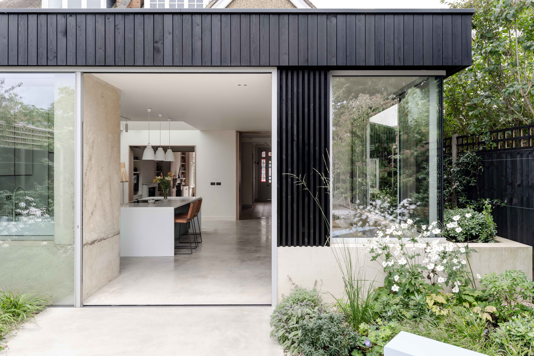 Matthew Giles Architects reworks suburban house with timber-clad extensions