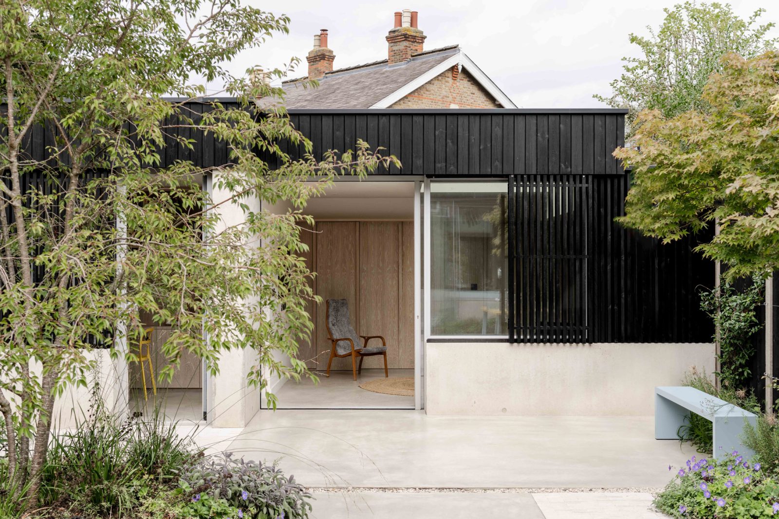 Matthew Giles Architects reworks suburban house with timber-clad extensions