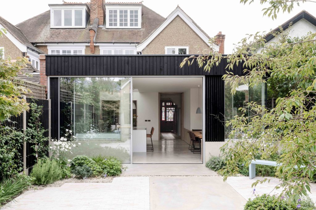 Matthew Giles Architects reworks suburban house with timber-clad extensions